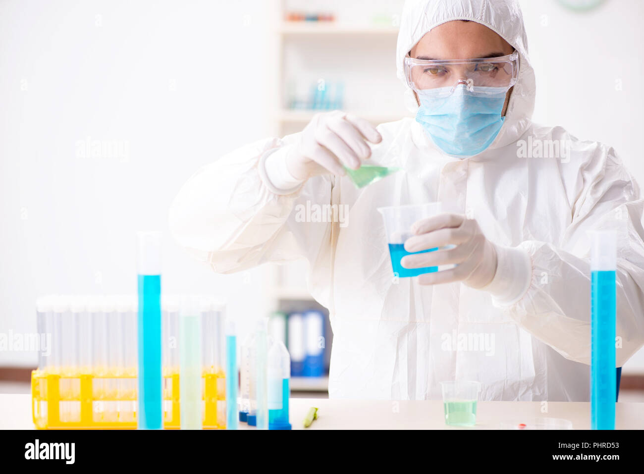 Young chemist student working in lab on chemicals Stock Photo - Alamy