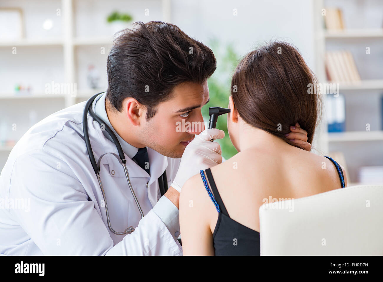 Doctor checking patients ear during medical examination Stock Photo - Alamy
