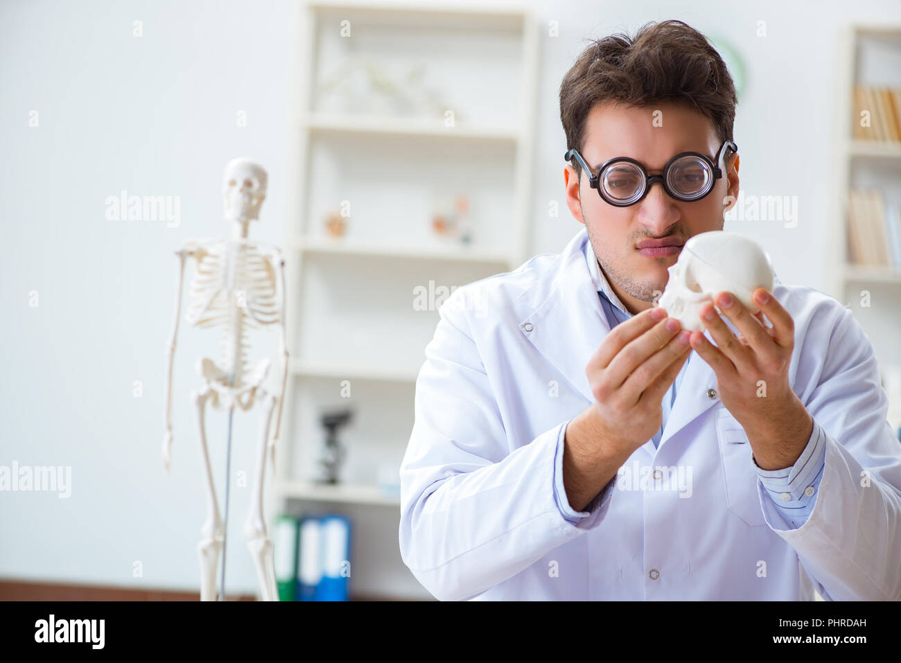 Crazy doctor studying human skeleton Stock Photo - Alamy
