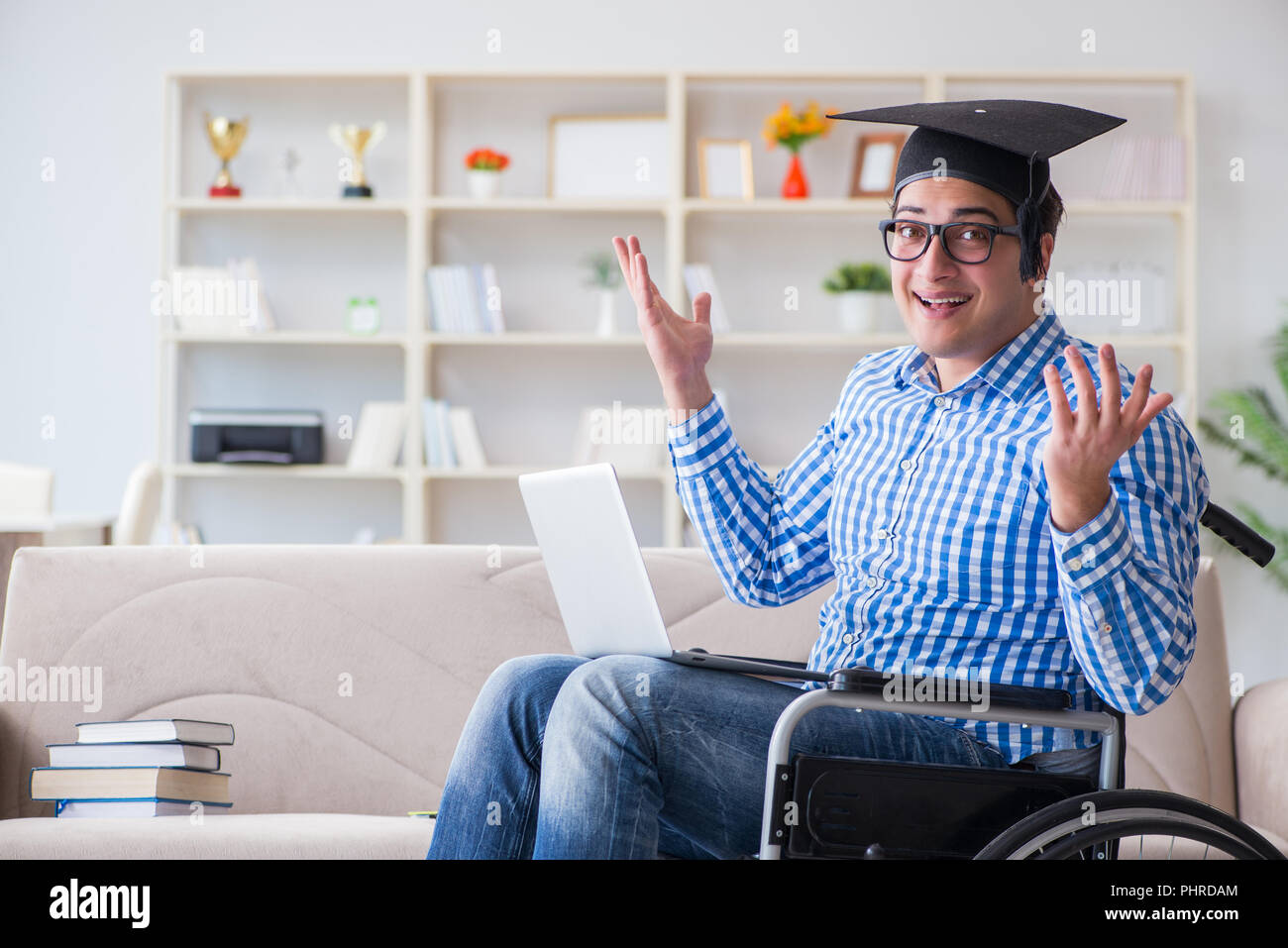 Young student on wheelchair in disability concept Stock Photo - Alamy