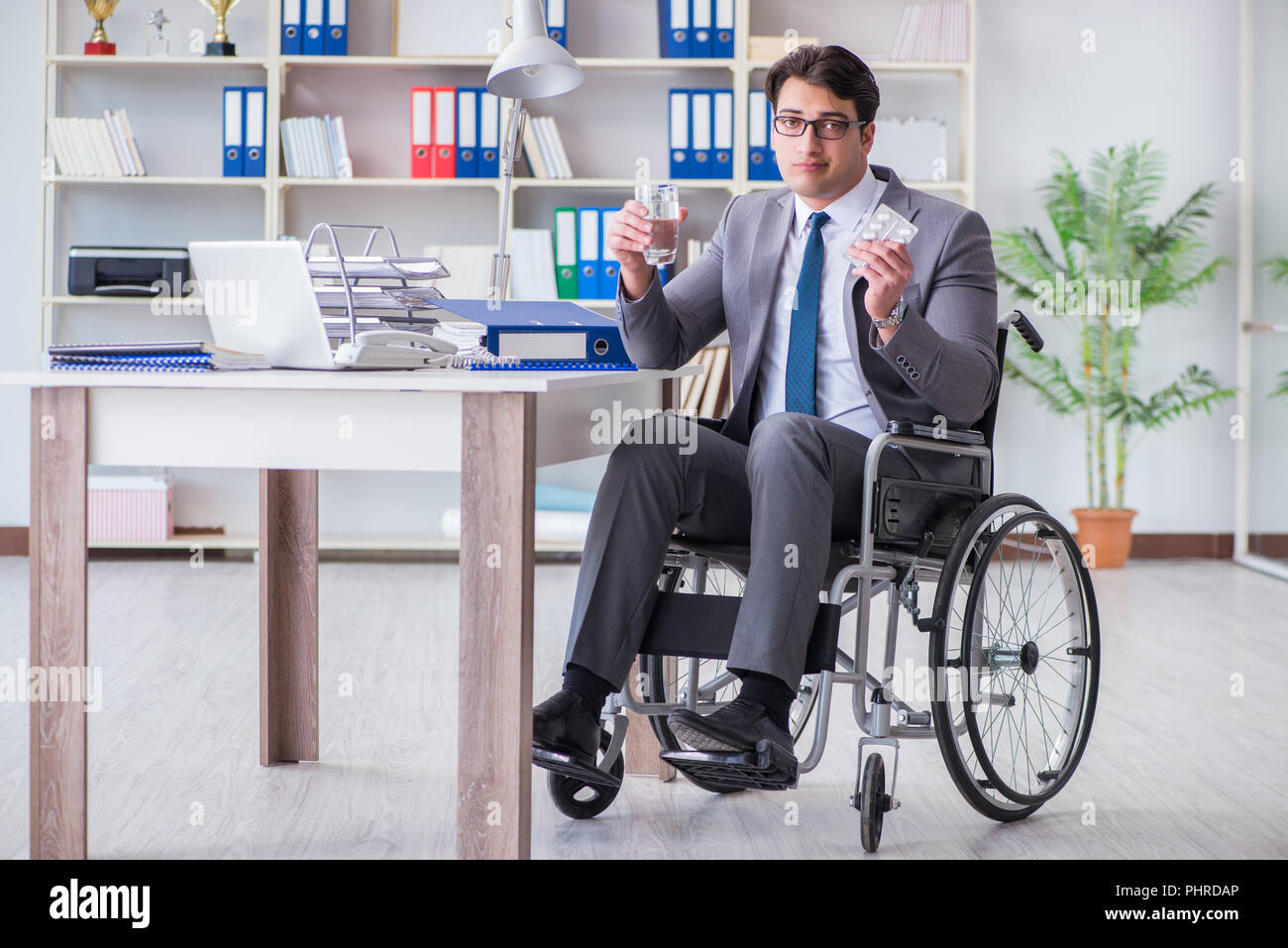 Disabled businessman working in the office Stock Photo - Alamy