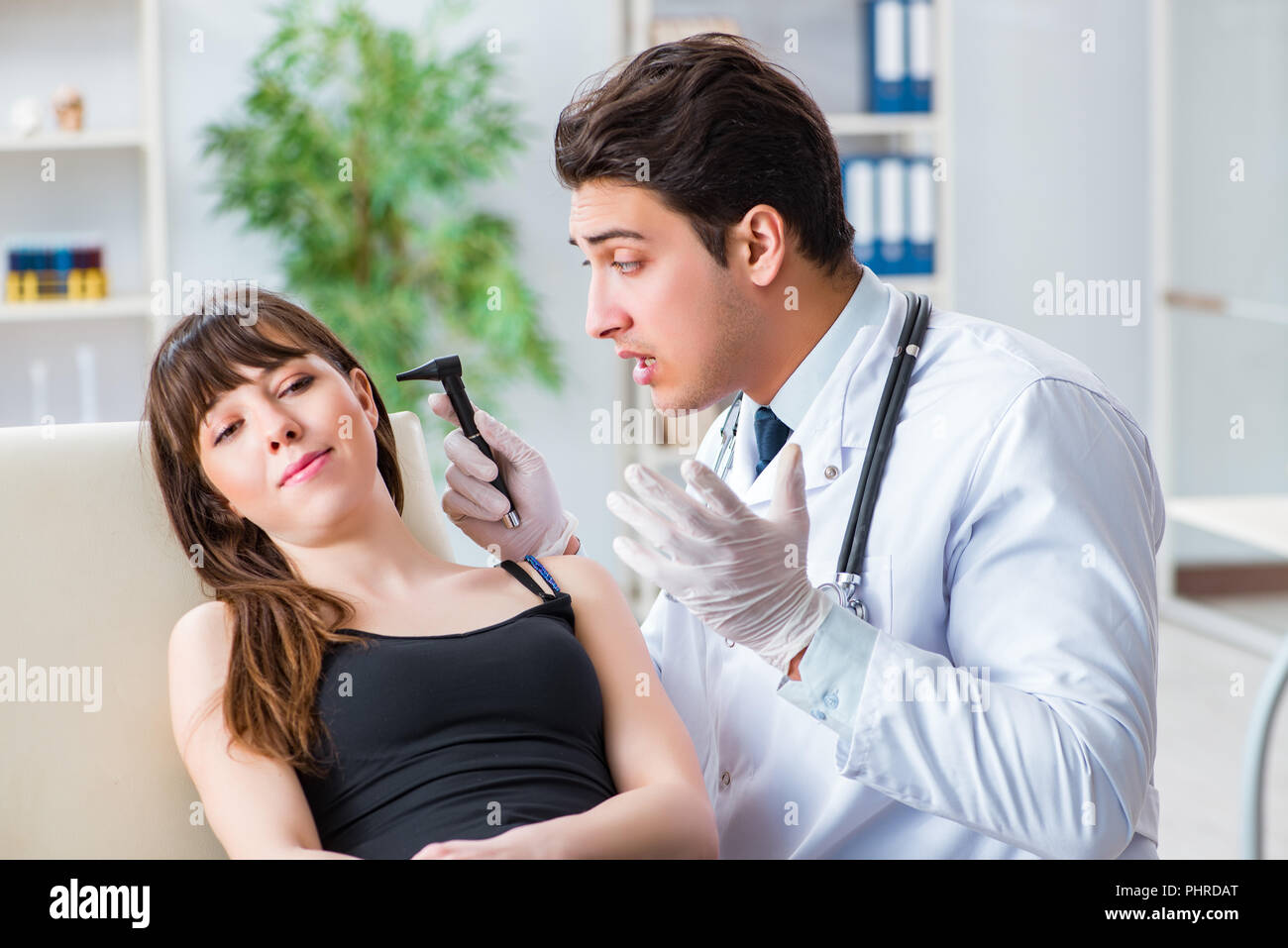 Doctor checking patients ear during medical examination Stock Photo - Alamy