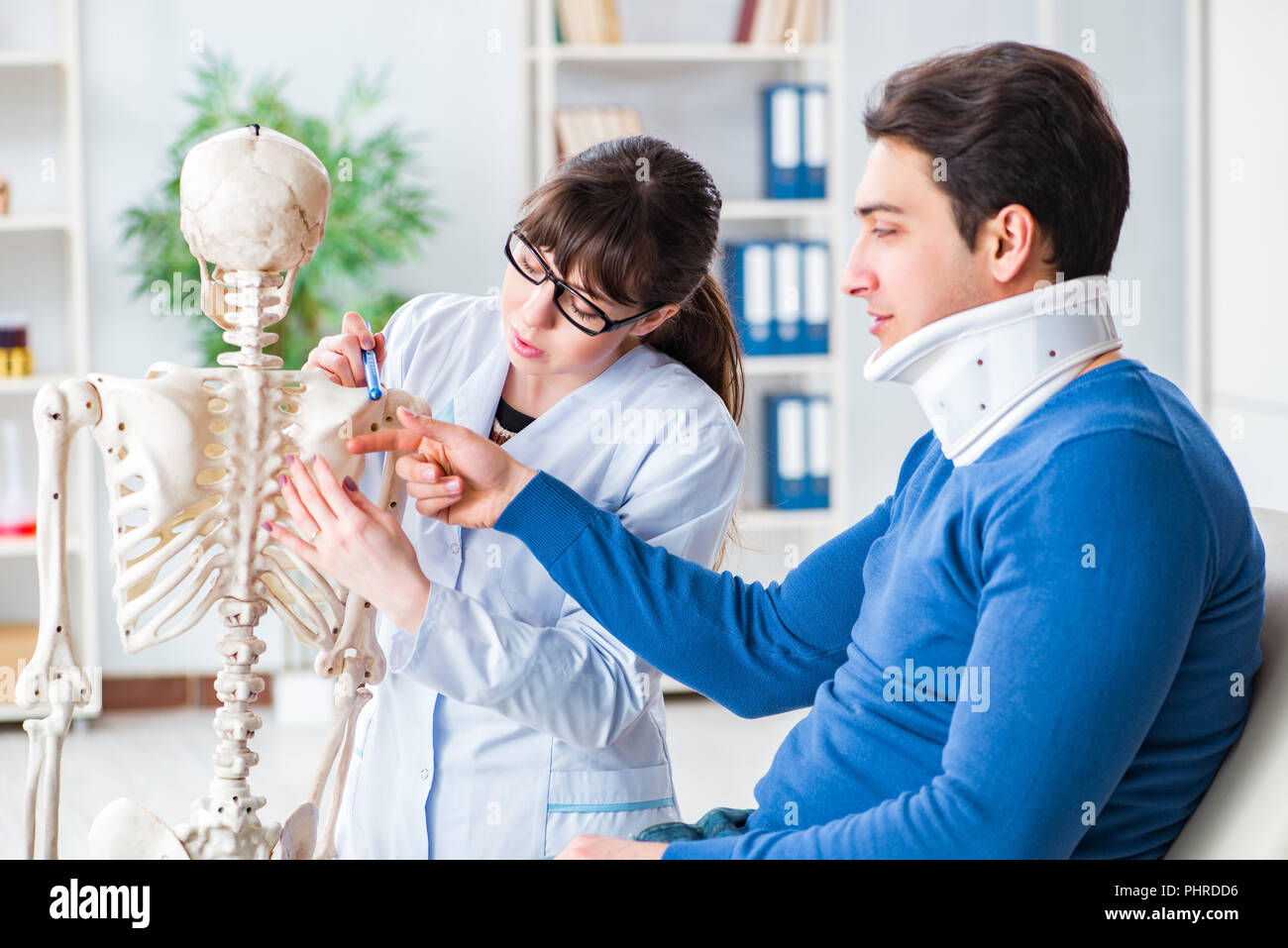 Doctor is explaining to patient with neck injury Stock Photo - Alamy