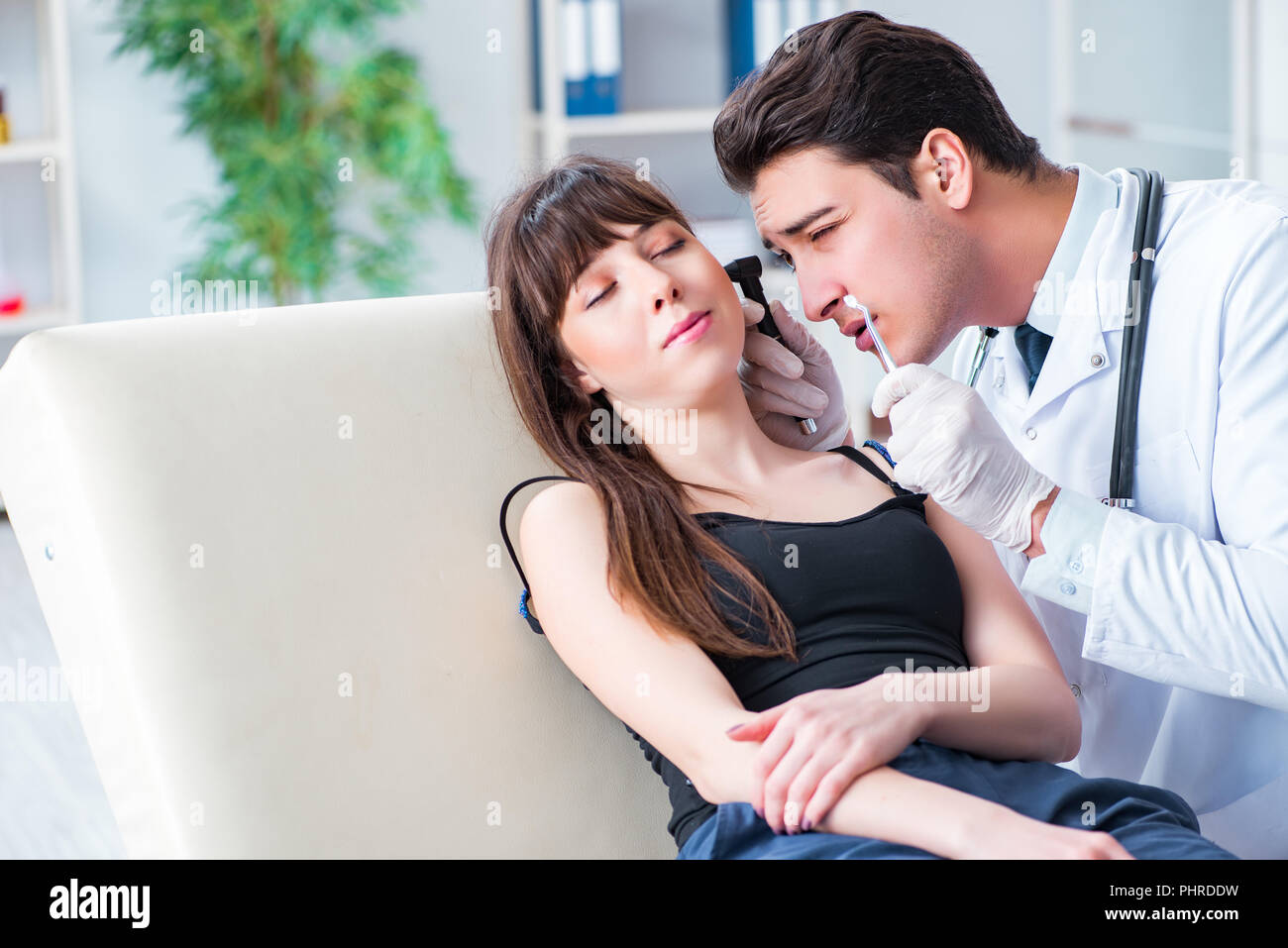 Doctor checking patients ear during medical examination Stock Photo - Alamy