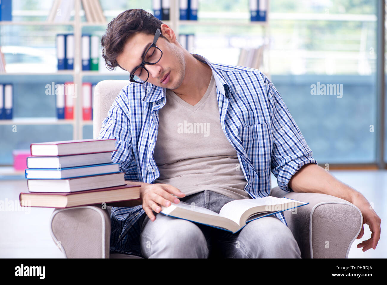 Student reading books and preparing for exams in library Stock Photo ...