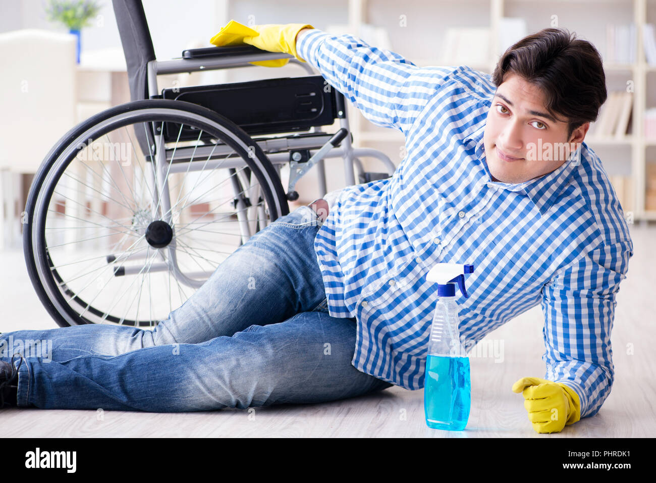 Disabled man on wheelchair cleaning home Stock Photo - Alamy