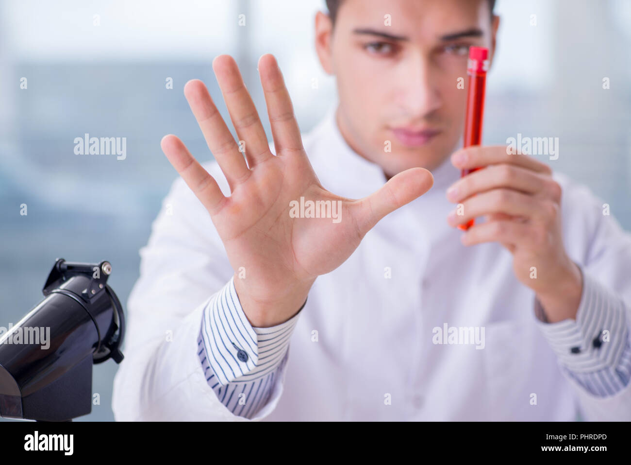 Man doctor checking blood samples in lab Stock Photo - Alamy