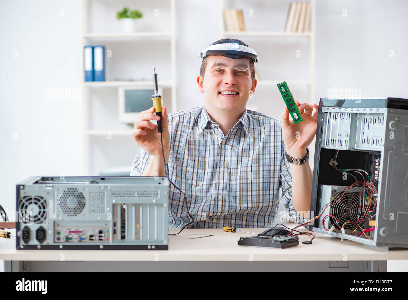 Technician examining motherboard magnifying hi-res stock photography ...