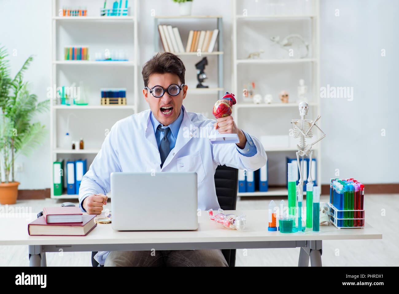 Funny doctor having fun in hospital lab Stock Photo - Alamy