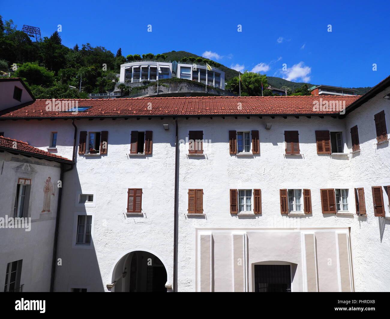 Elevation of white medieval courtyard of Madonna del Sasso church in ...