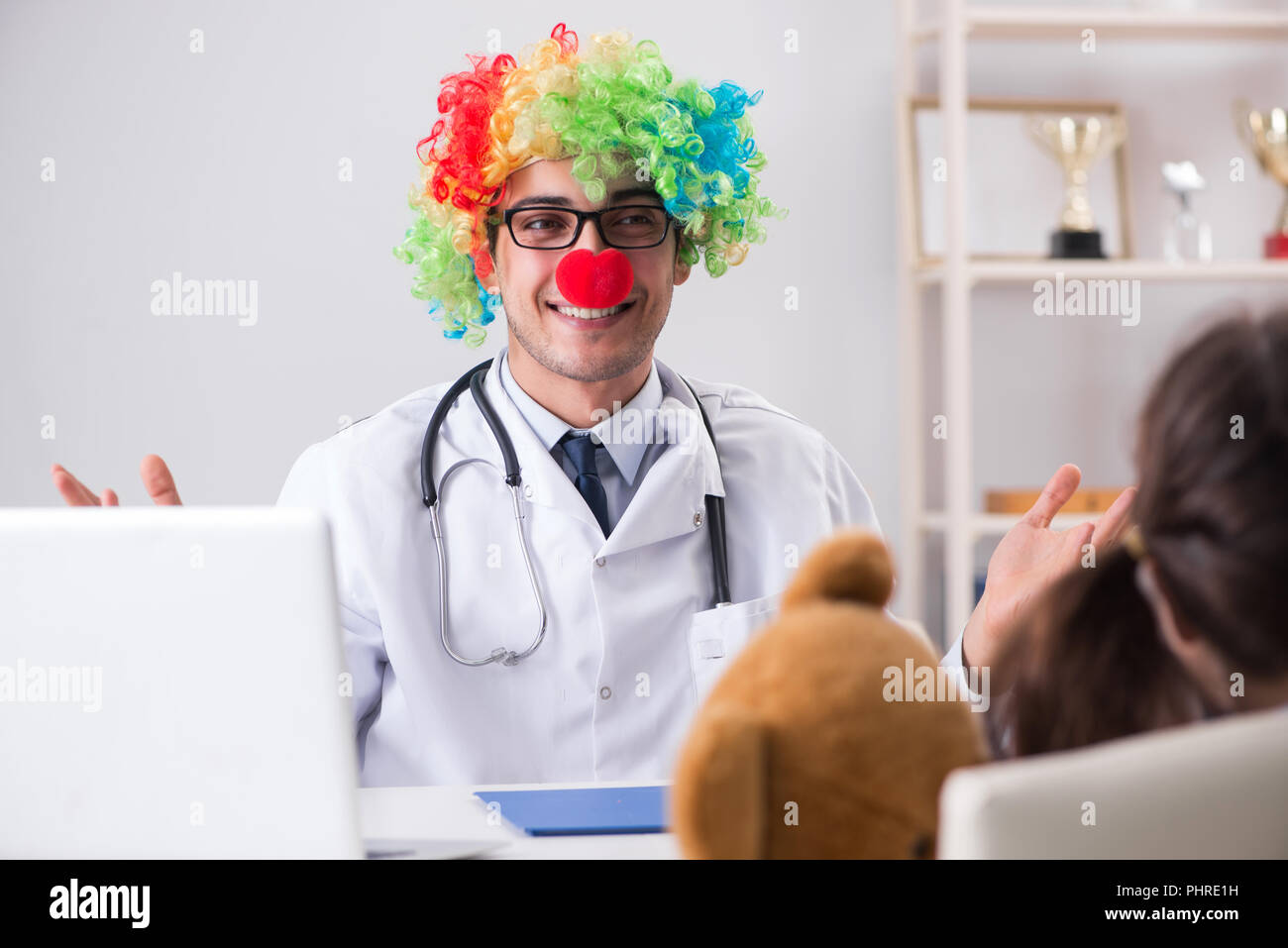 Funny pediatrician with little girl at regular check-up Stock Photo - Alamy