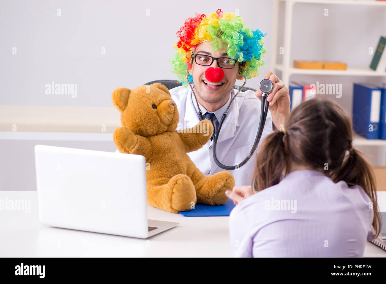 Funny pediatrician with little girl at regular check-up Stock Photo - Alamy