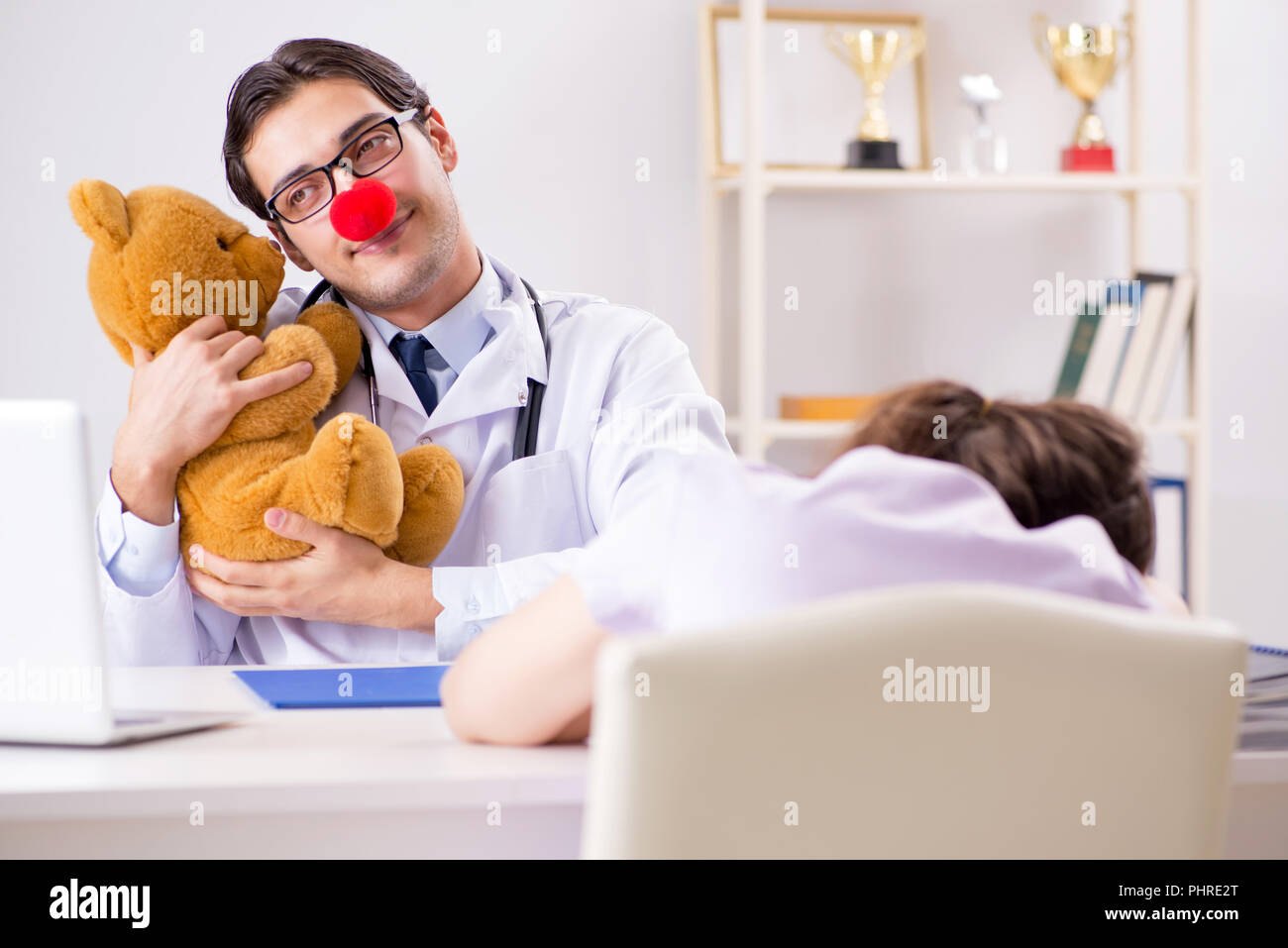 Funny pediatrician with little girl at regular check-up Stock Photo - Alamy