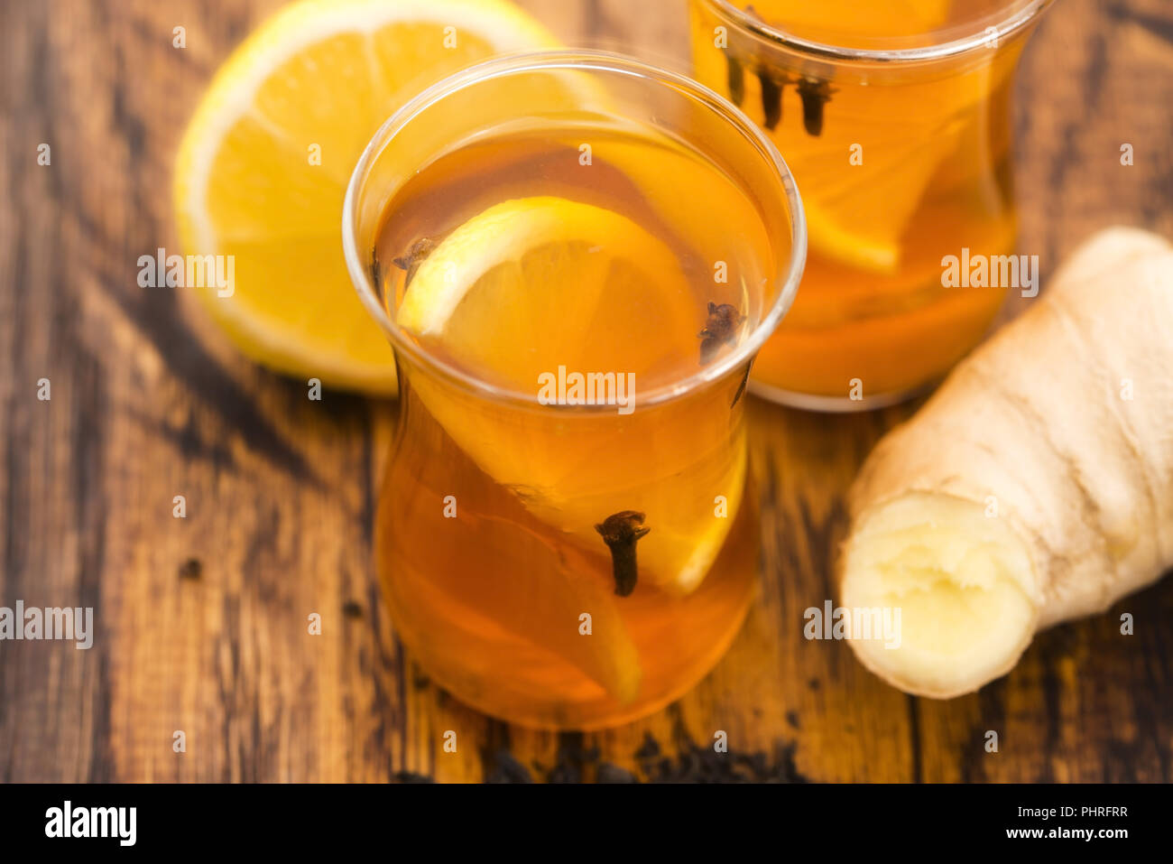 Black tea with lemon and ginger Stock Photo - Alamy