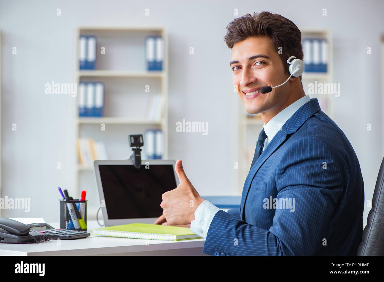 Young help desk operator working in office Stock Photo - Alamy