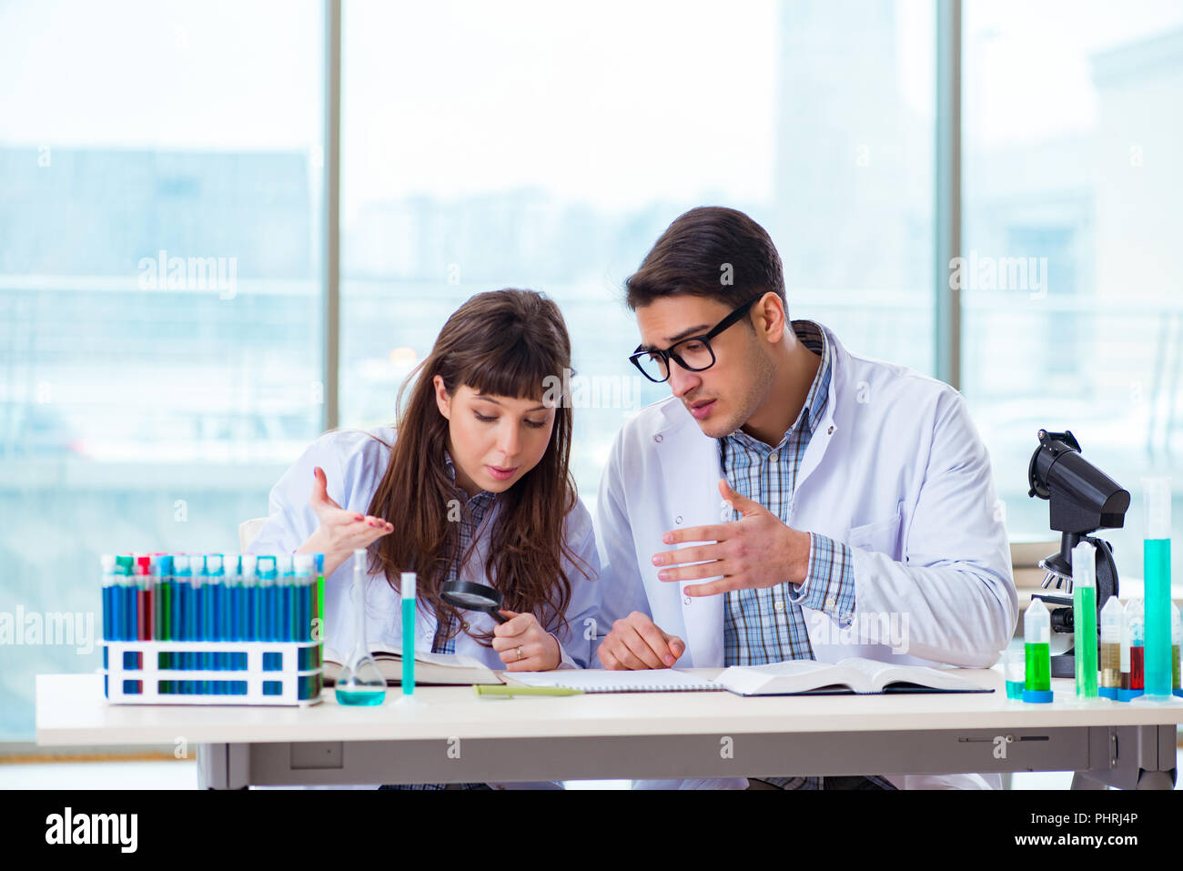 Two chemists working in lab experimenting Stock Photo - Alamy