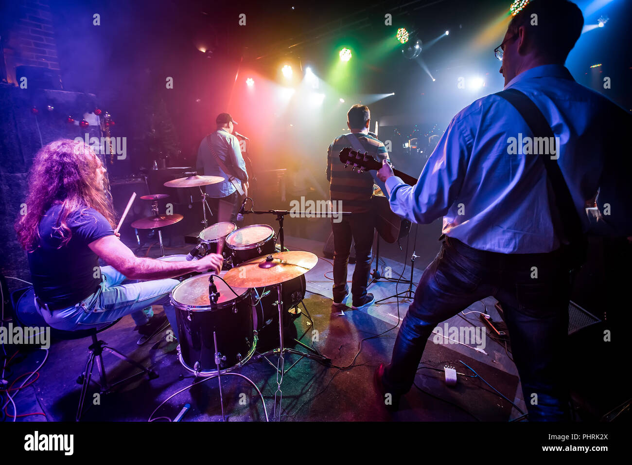 Band performs on stage, rock music concert in a nightclub. Authentic ...