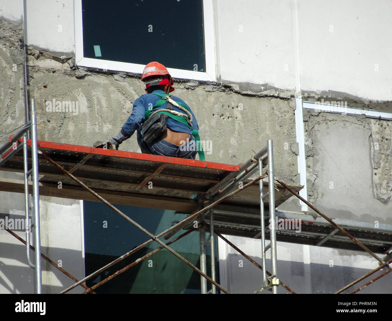 Construction workers plastering wall using cement plaster at the ...