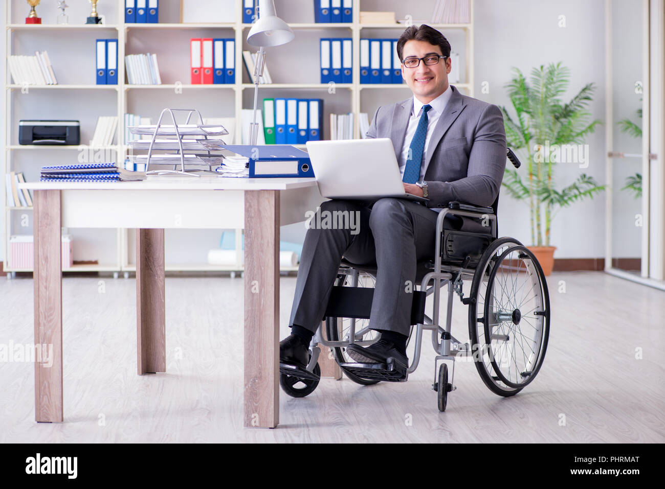 Disabled businessman working in the office Stock Photo - Alamy