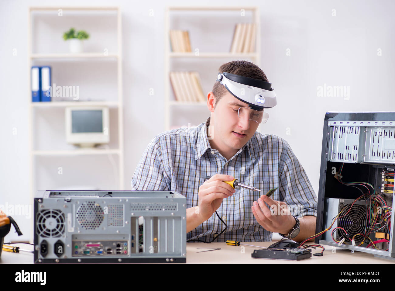 Technician examining motherboard magnifying hi-res stock photography ...