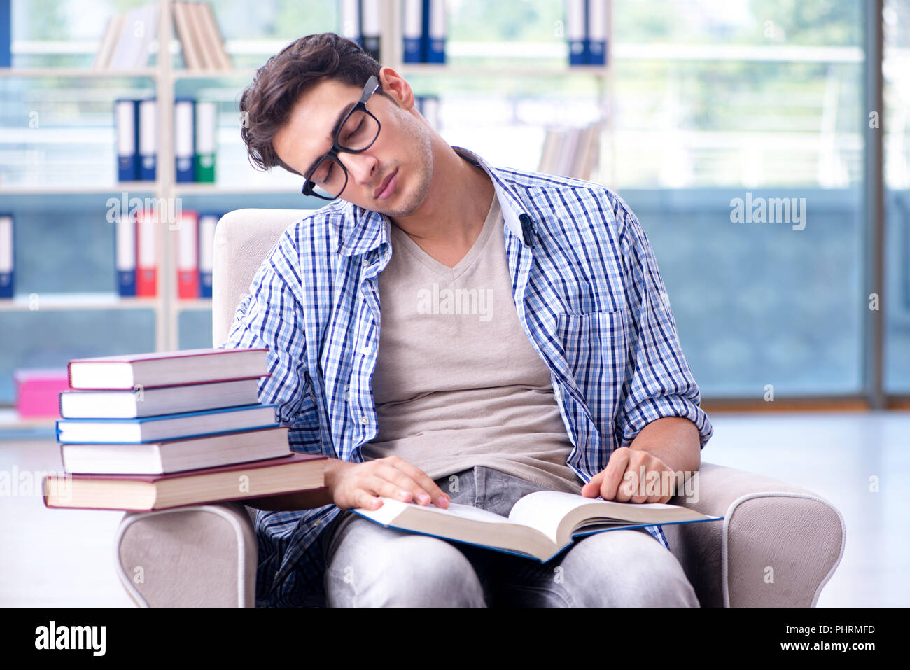 Student reading books and preparing for exams in library Stock Photo ...
