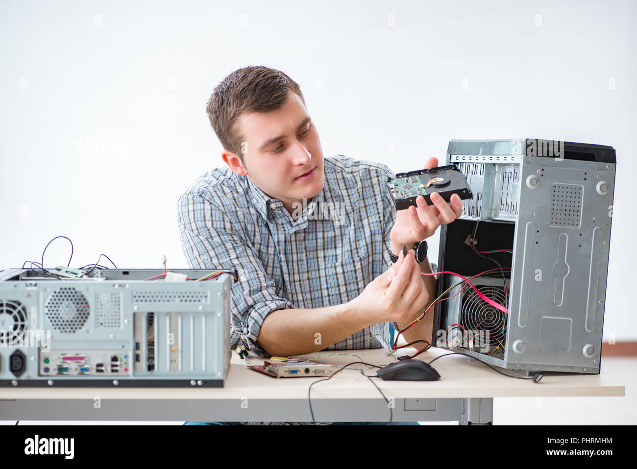 Young technician repairing computer in workshop Stock Photo - Alamy