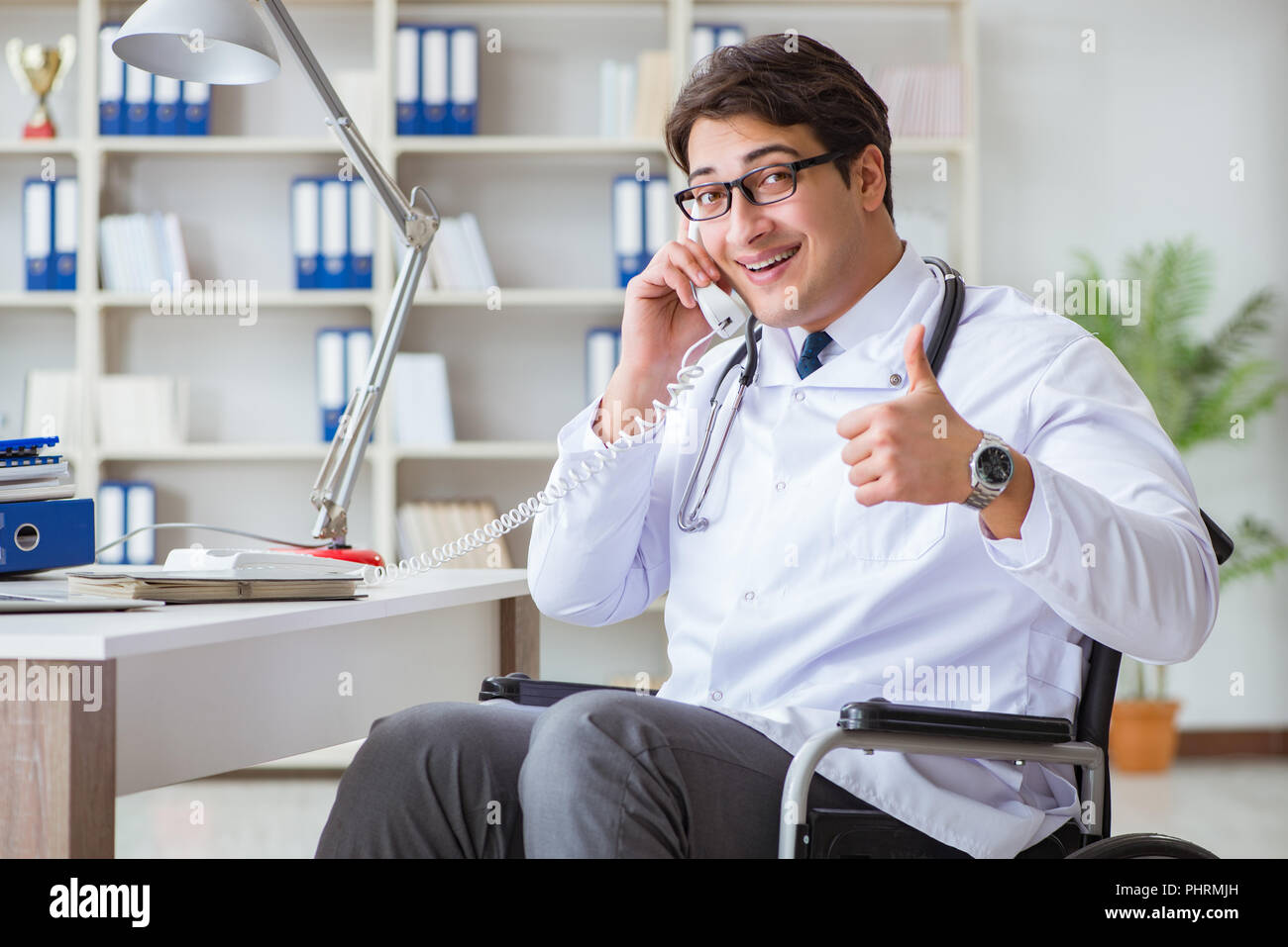 Disabled doctor on wheelchair working in hospital Stock Photo - Alamy