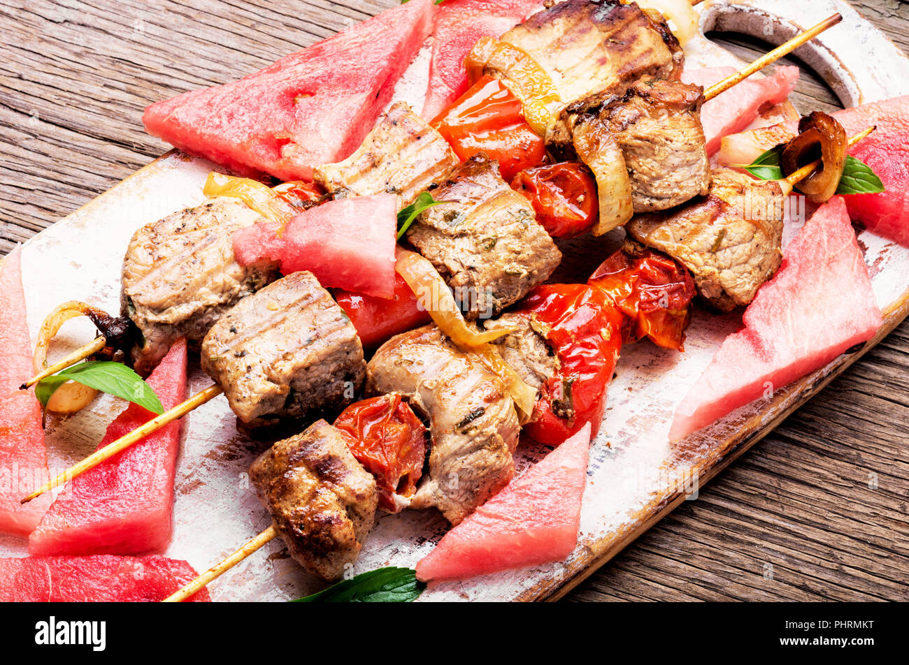 Meat, shish kebab on skewers with watermelon. Summer recipe for shish ...