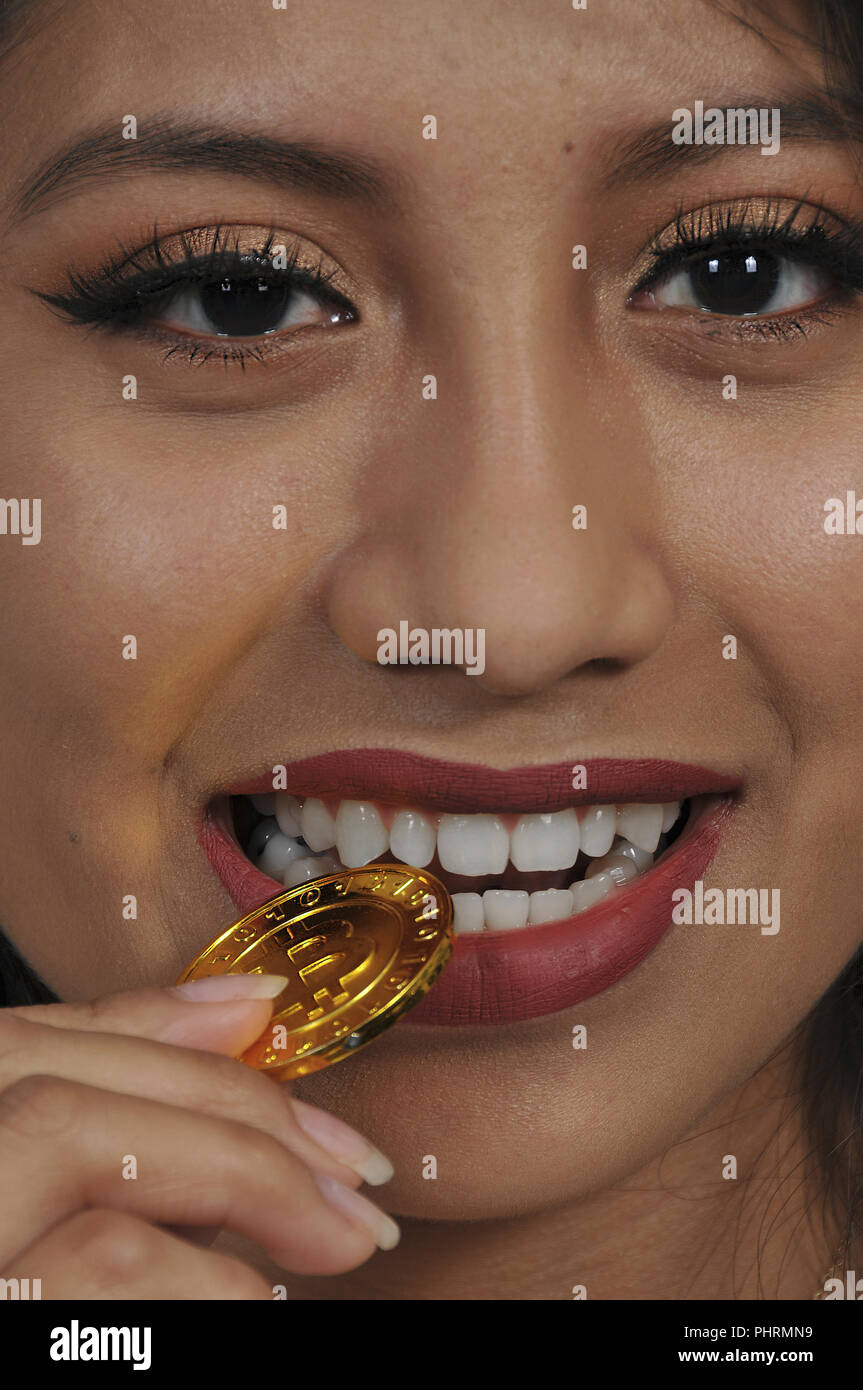 Biting gold coin bitcoin hi-res stock photography and images - Alamy