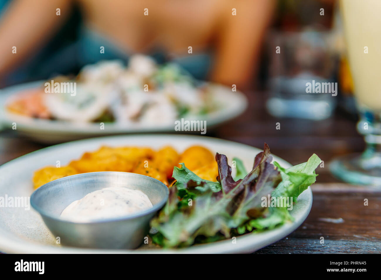 Eating Spring Rolls And Salad In Restaurant Stock Photo - Alamy