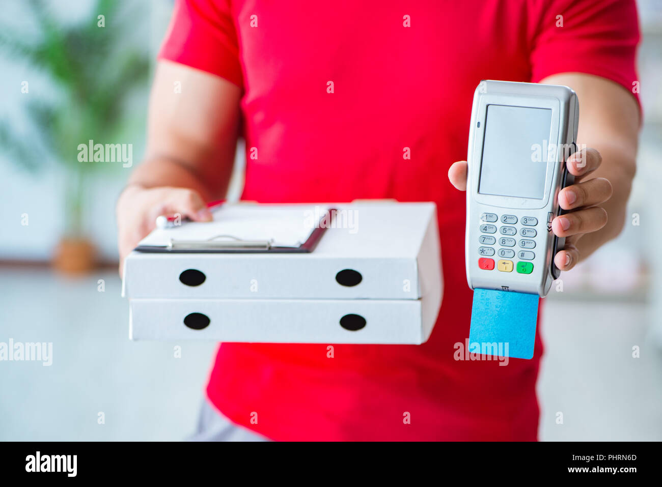 Pizza delivery being paid with pos and credit card Stock Photo - Alamy