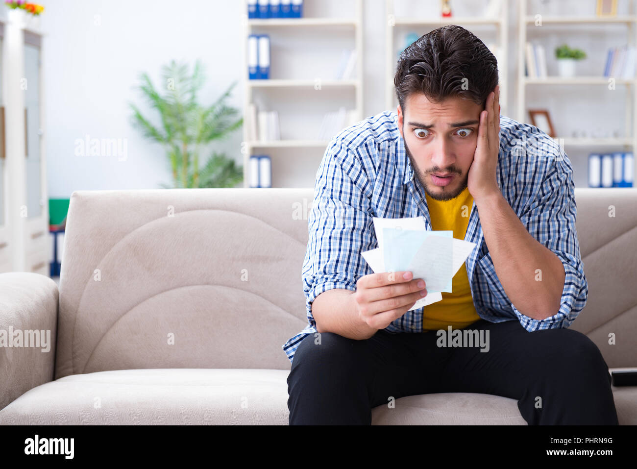 Man angry at bills he needs to pay Stock Photo - Alamy