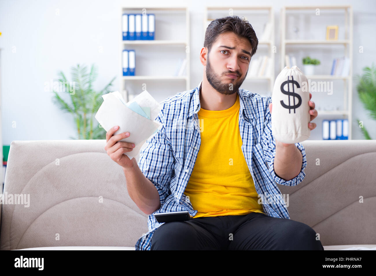 Man angry at bills he needs to pay Stock Photo - Alamy