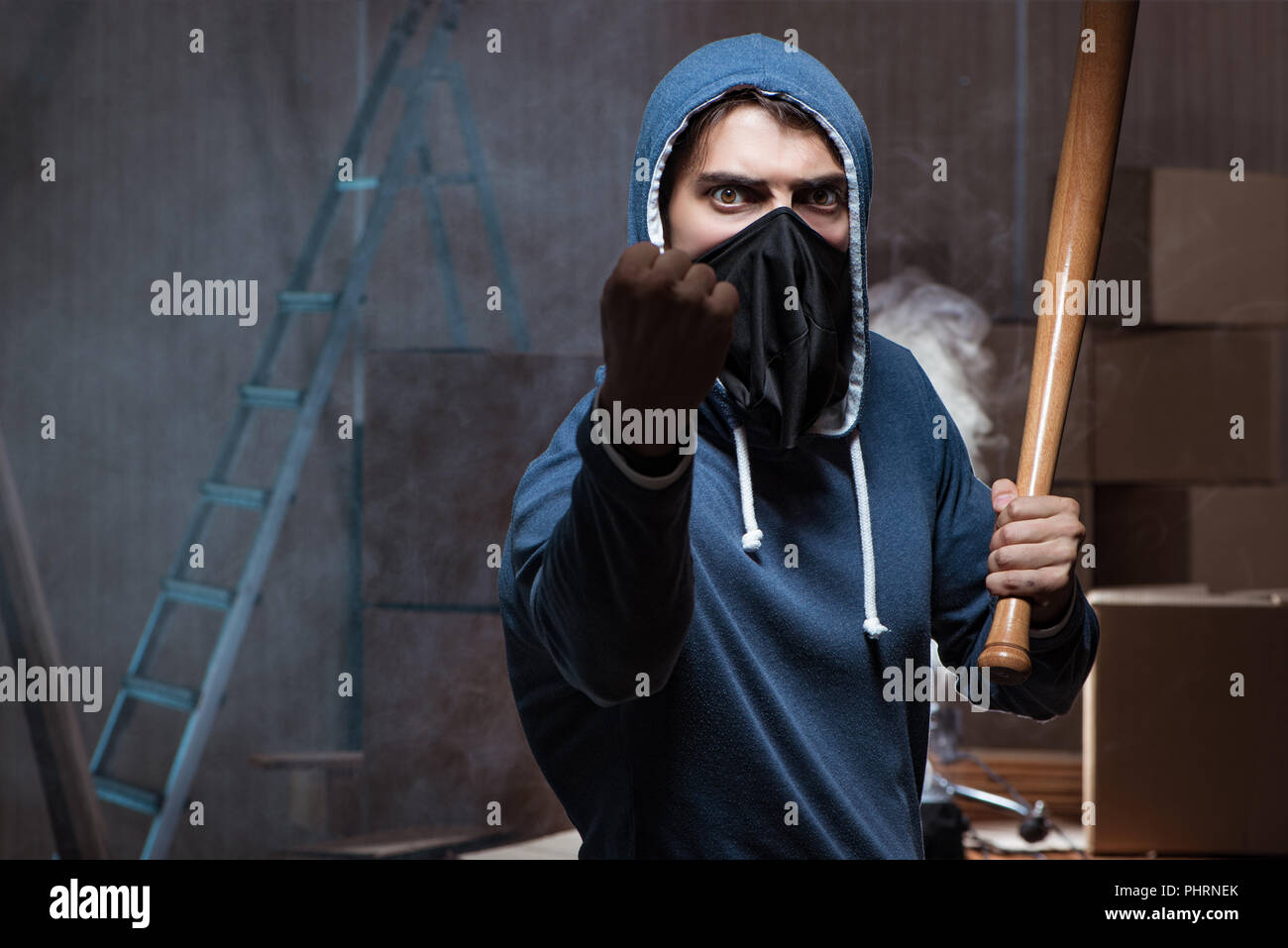 Hooligan with bat in dark room Stock Photo - Alamy