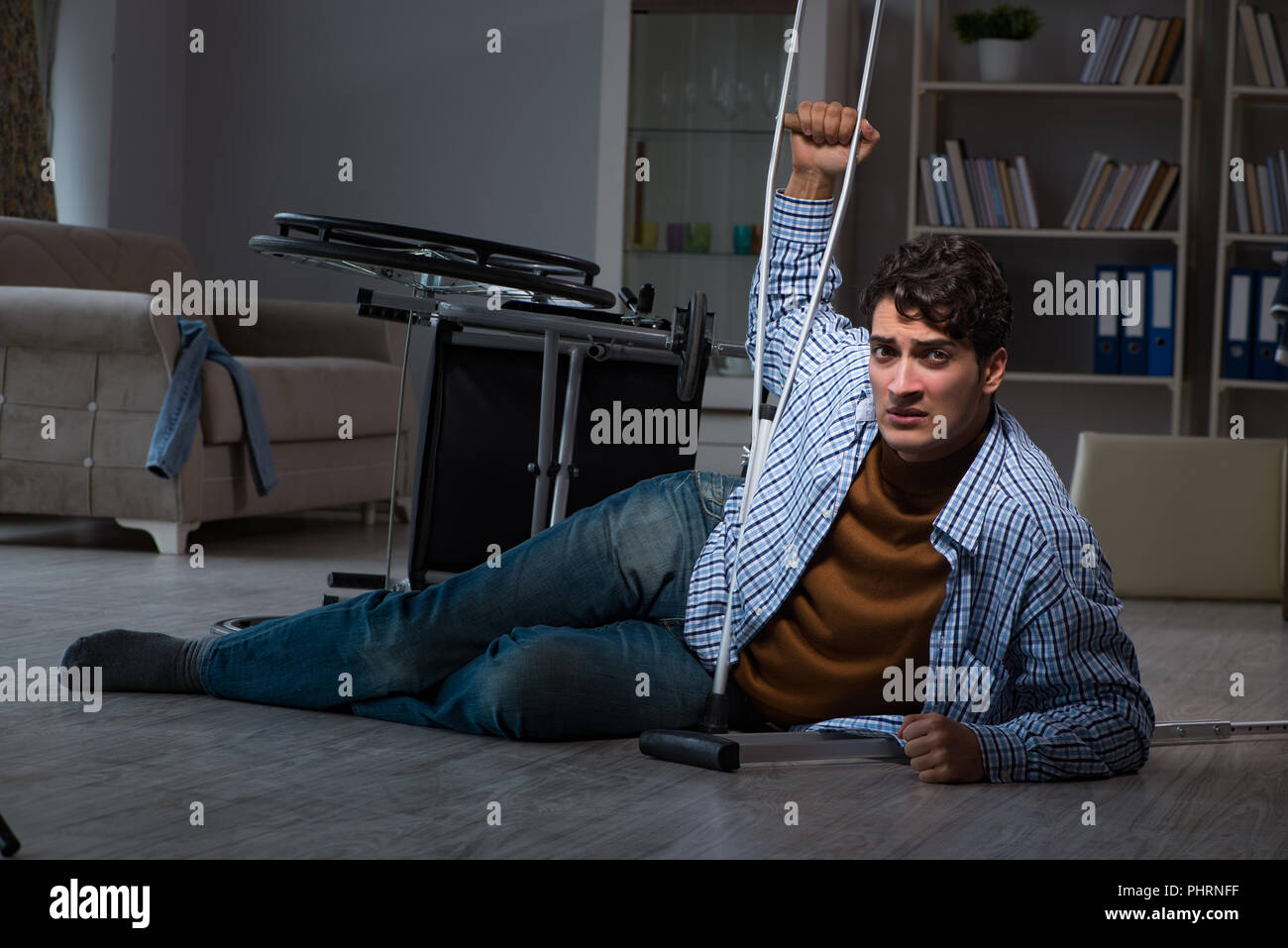 Man fell off wheelchair sitting on the floor Stock Photo - Alamy