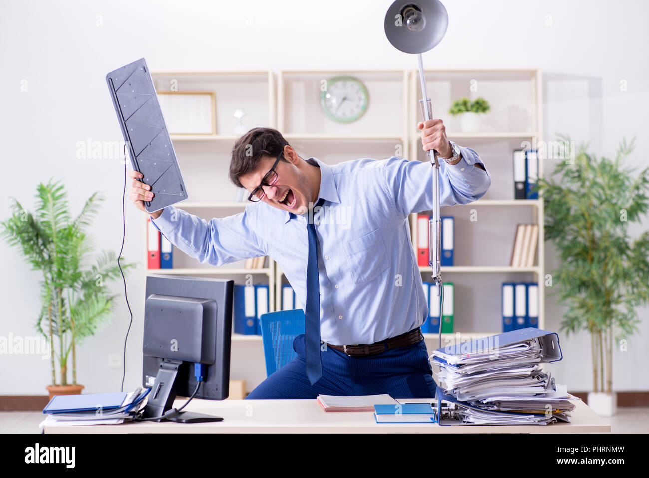 Angry businessman frustrated with too much work Stock Photo - Alamy