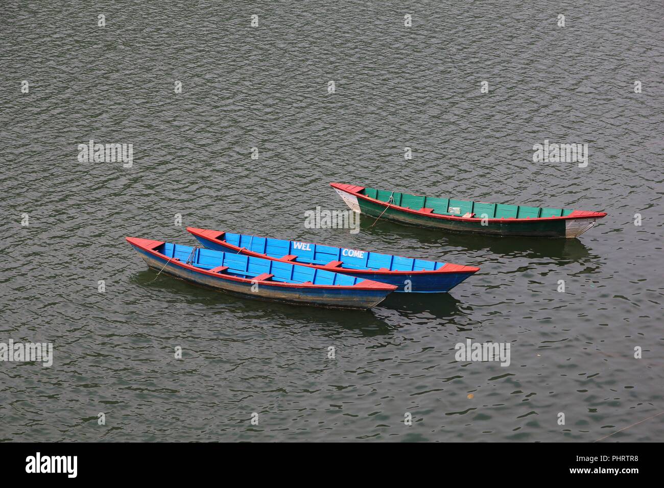 Beautiful timber rowing boats on Fewa lake, Nepal Stock Photo - Alamy