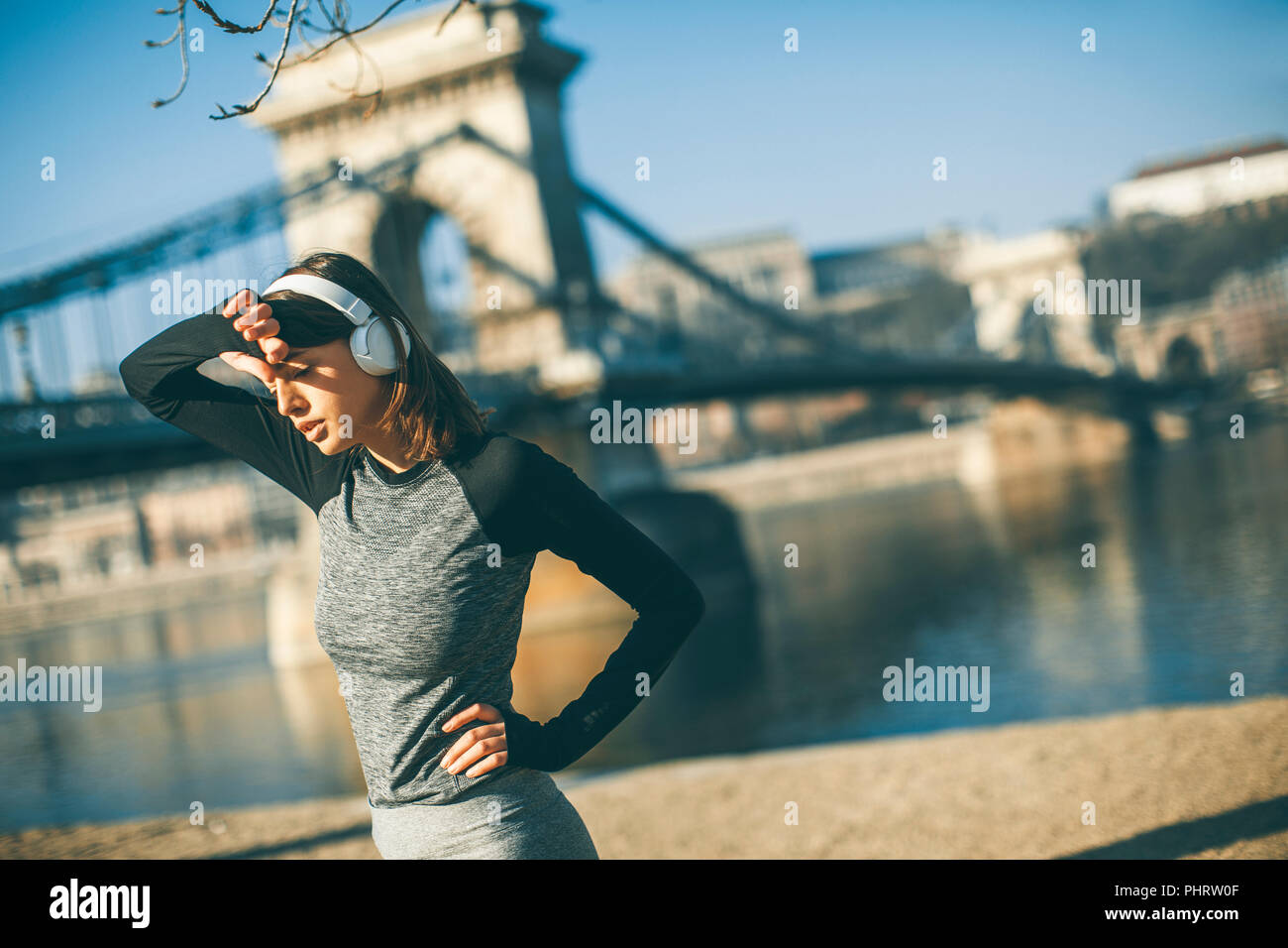Young female athlete taking break from running workout outdoor Stock ...