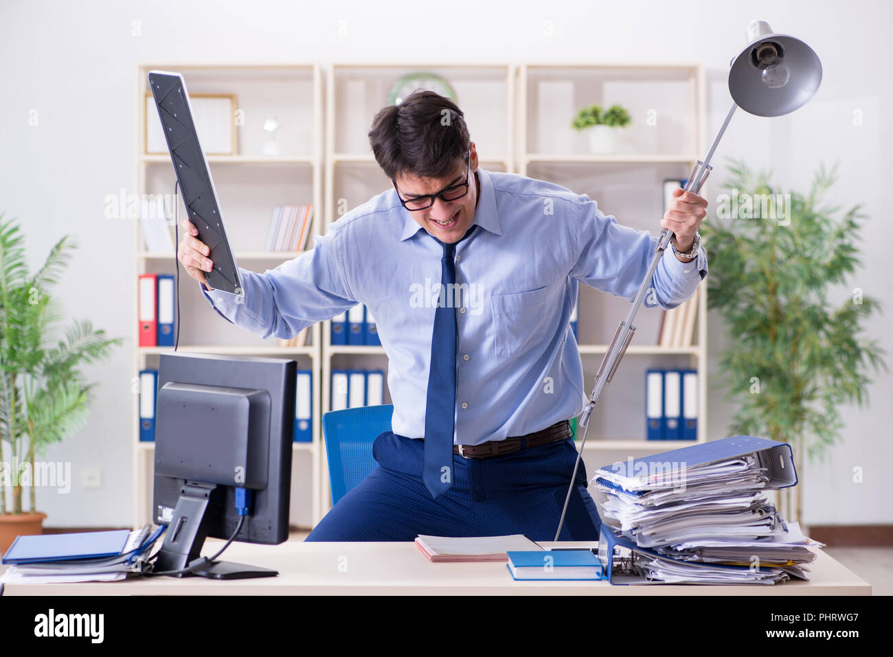 Angry businessman frustrated with too much work Stock Photo - Alamy