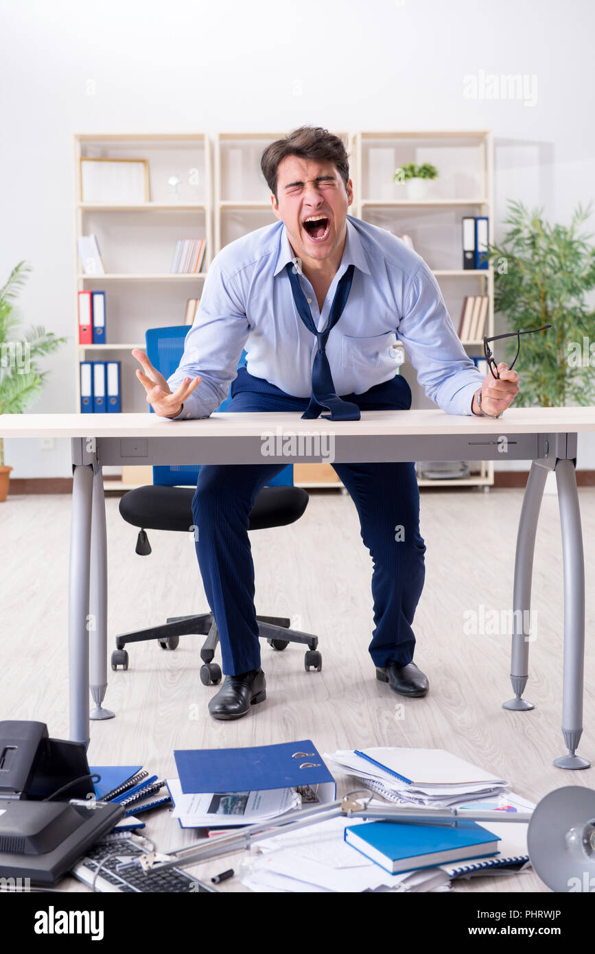 Angry businessman frustrated with too much work Stock Photo - Alamy