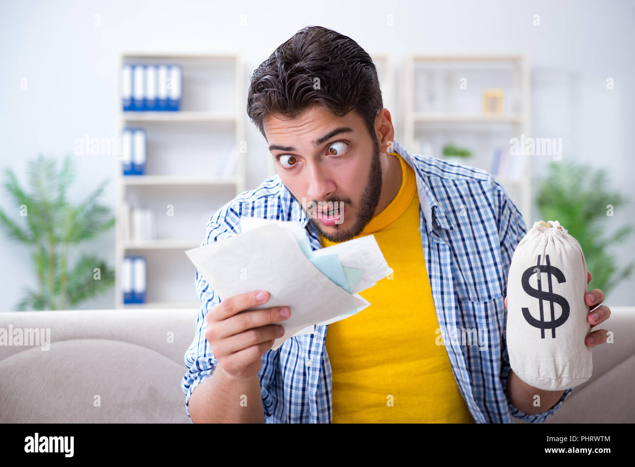 Man angry at bills he needs to pay Stock Photo - Alamy