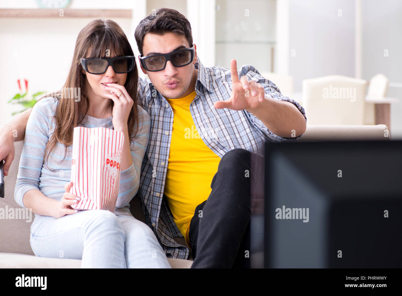 Happy family watching 3d movie hi-res stock photography and images - Alamy