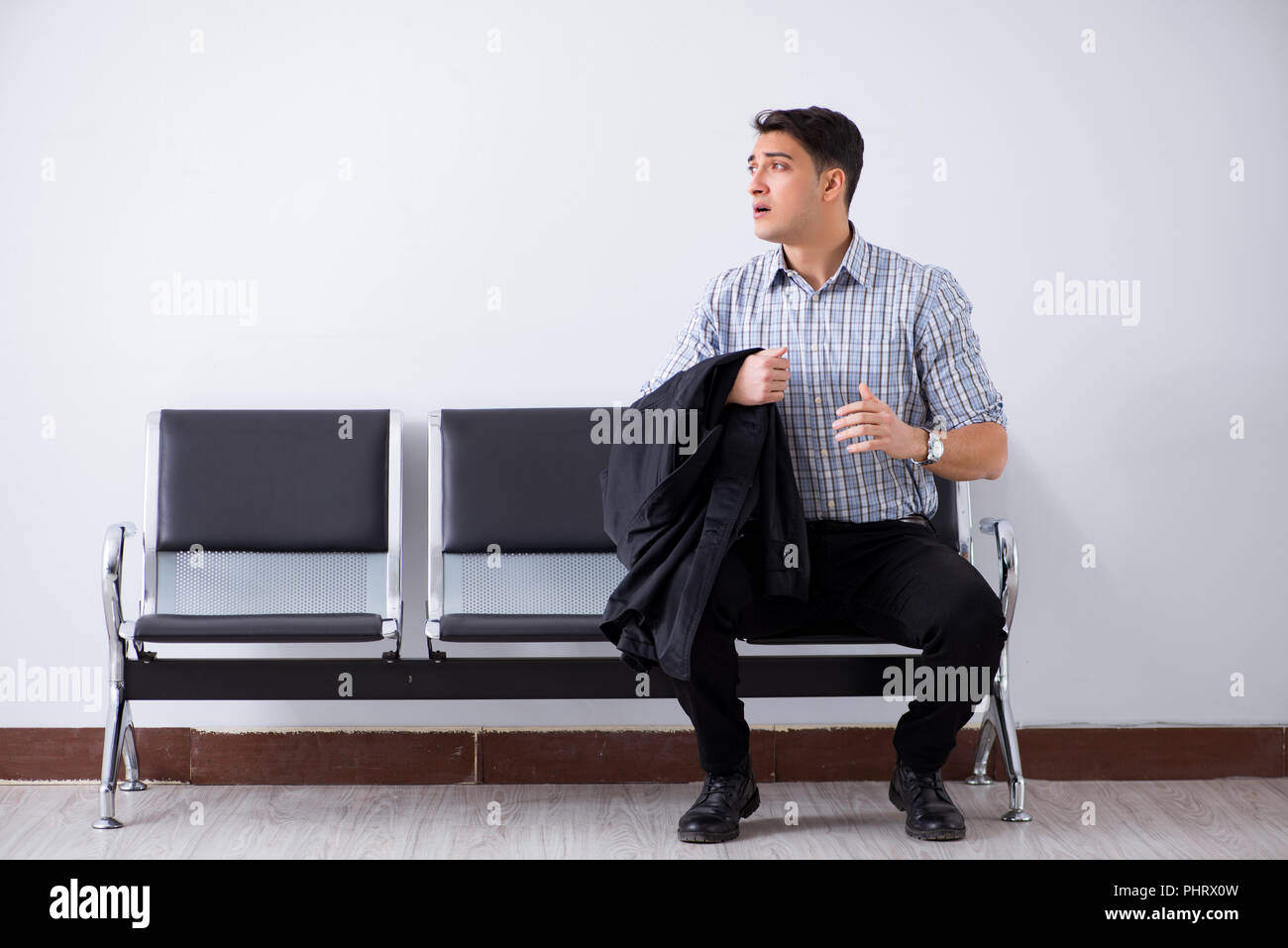 Man nervously impatiently waiting in the lobby Stock Photo - Alamy