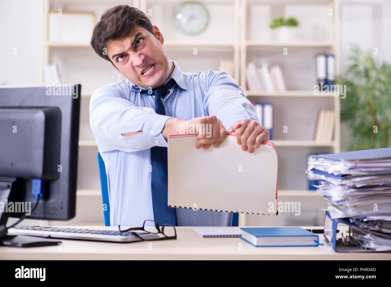 Tired businessman with too much paperwork Stock Photo - Alamy