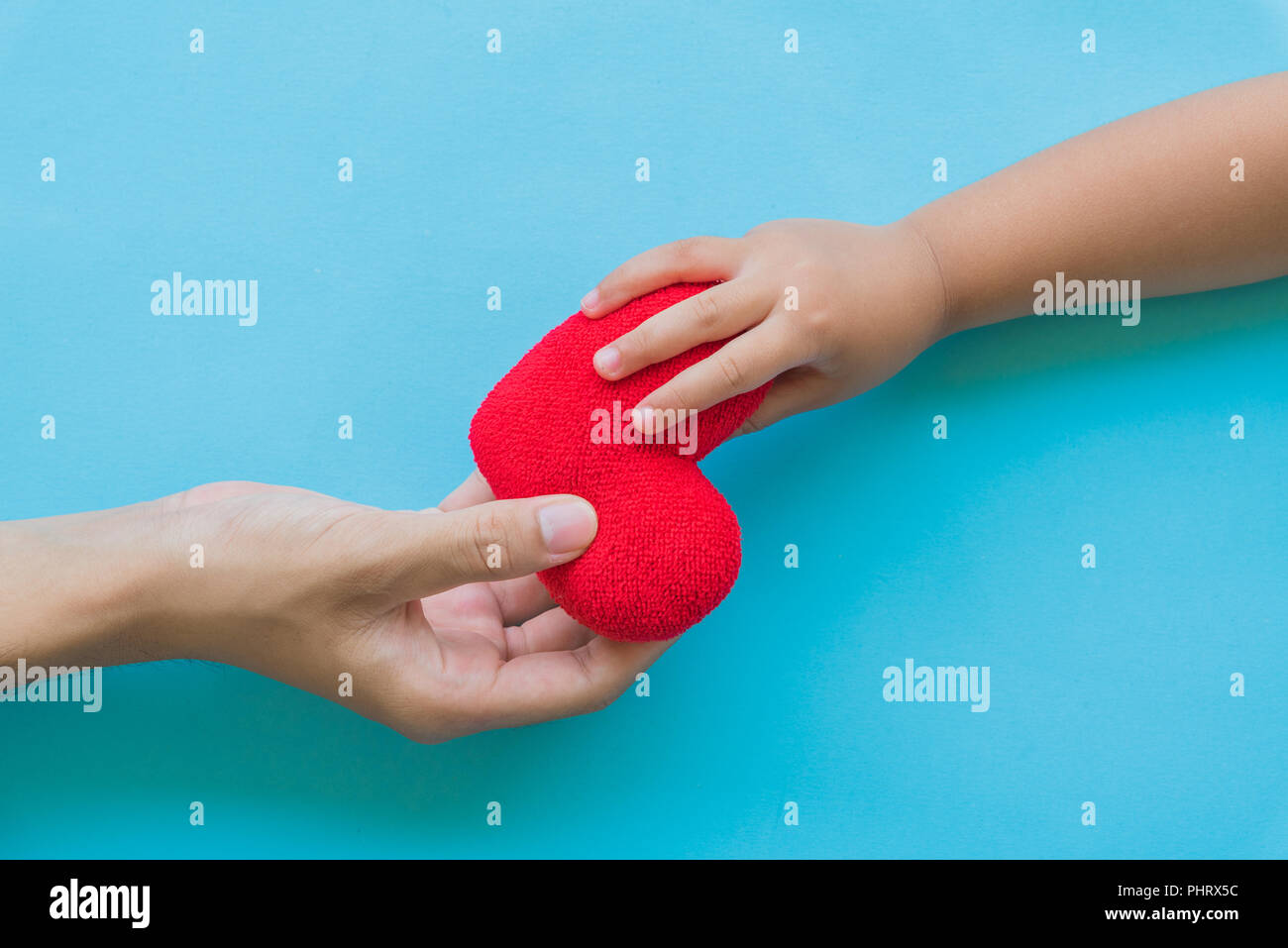 Child hand giving red heart to her dad, Happy family relationships ...