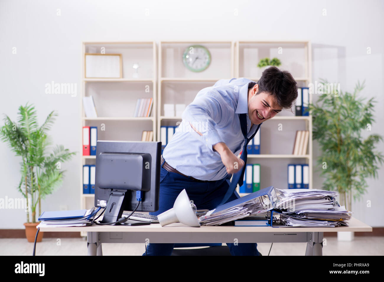 Angry businessman frustrated with too much work Stock Photo - Alamy