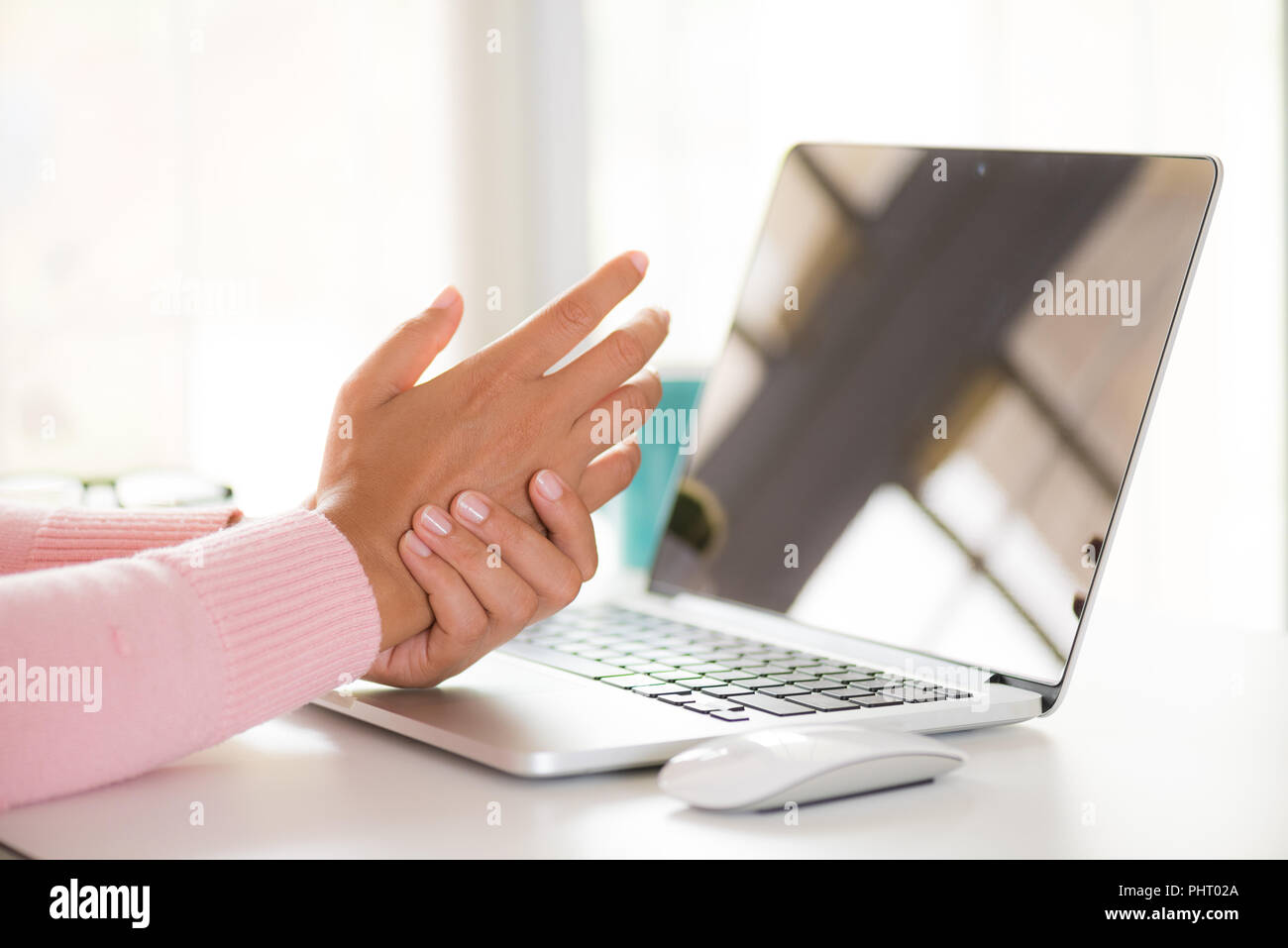 Closeup woman holding her wrist pain from using computer. Office ...