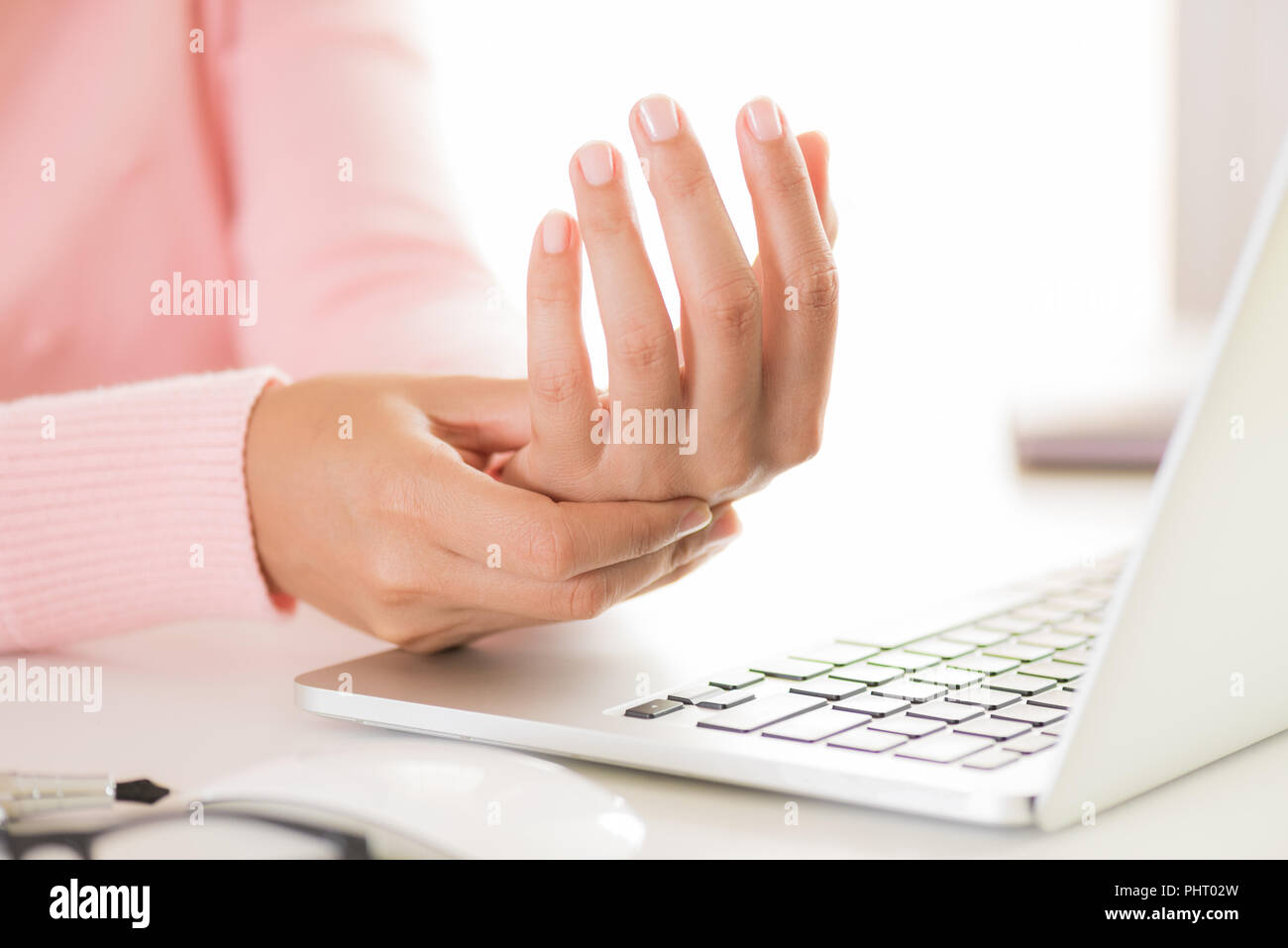 Closeup woman holding her wrist pain from using computer. Office ...