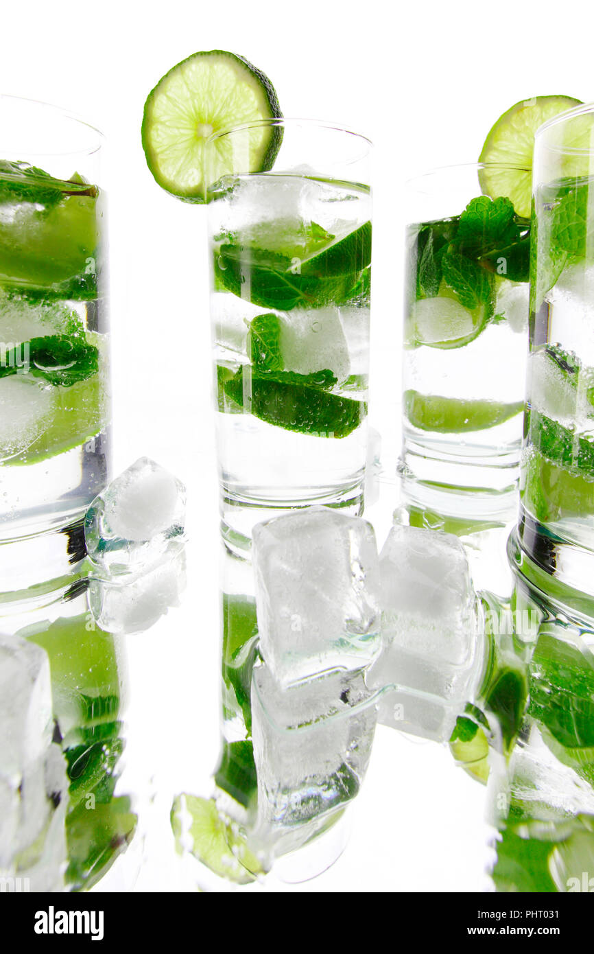 Party mojito cocktails with lime and mint isolated on white background ...