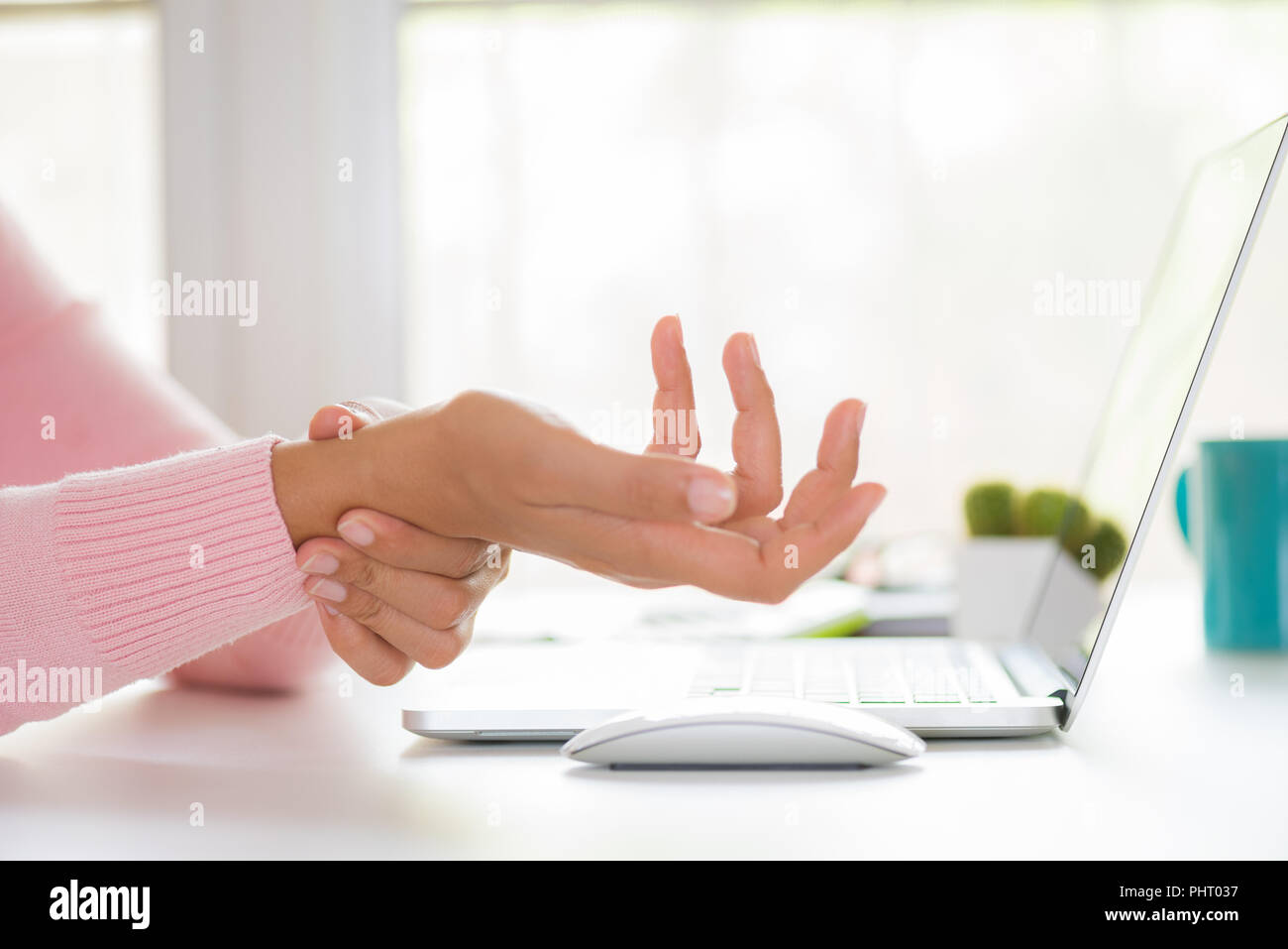Closeup woman holding her wrist pain from using computer. Office ...